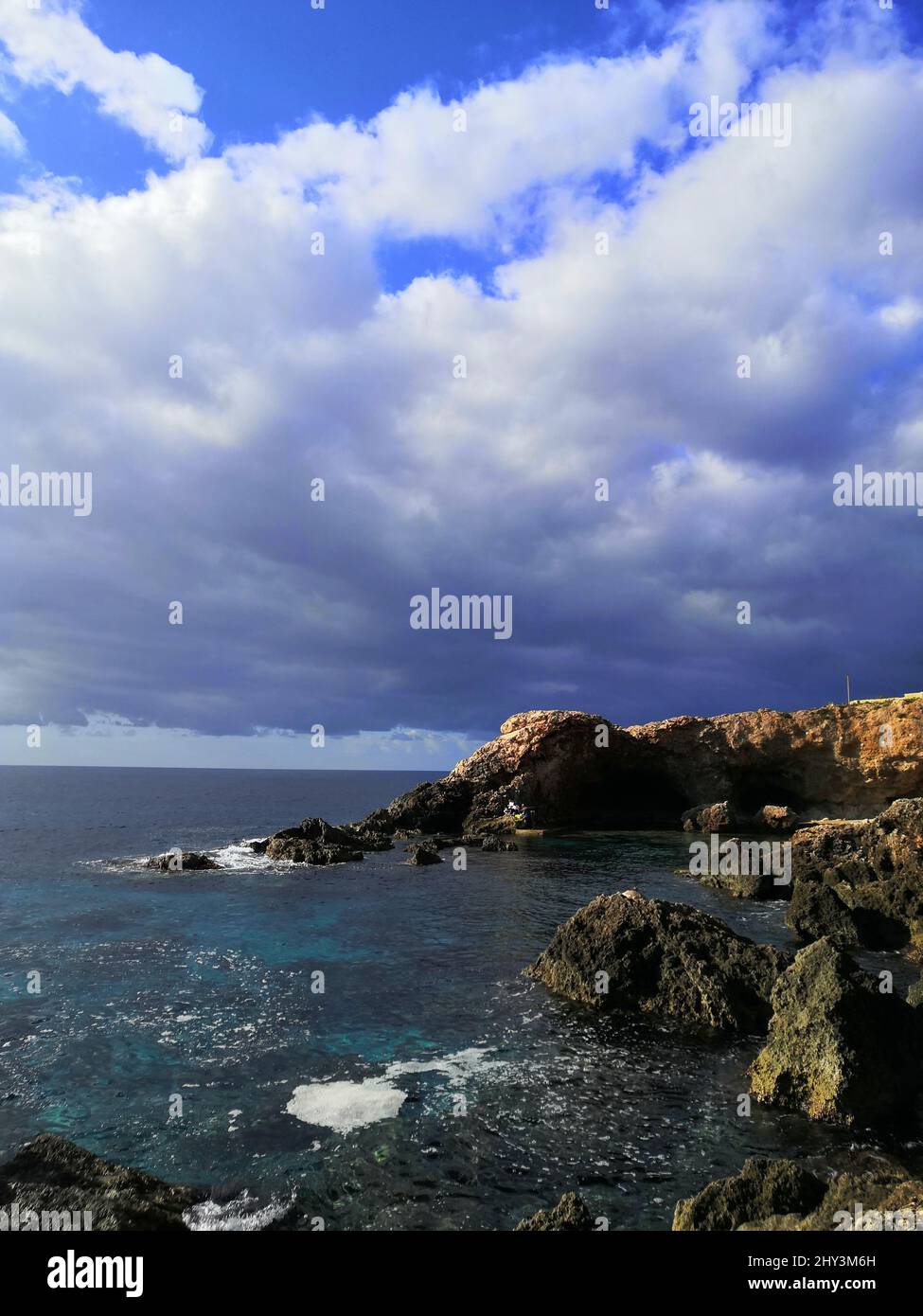 Photo of rocks going into the ocean Stock Photo - Alamy