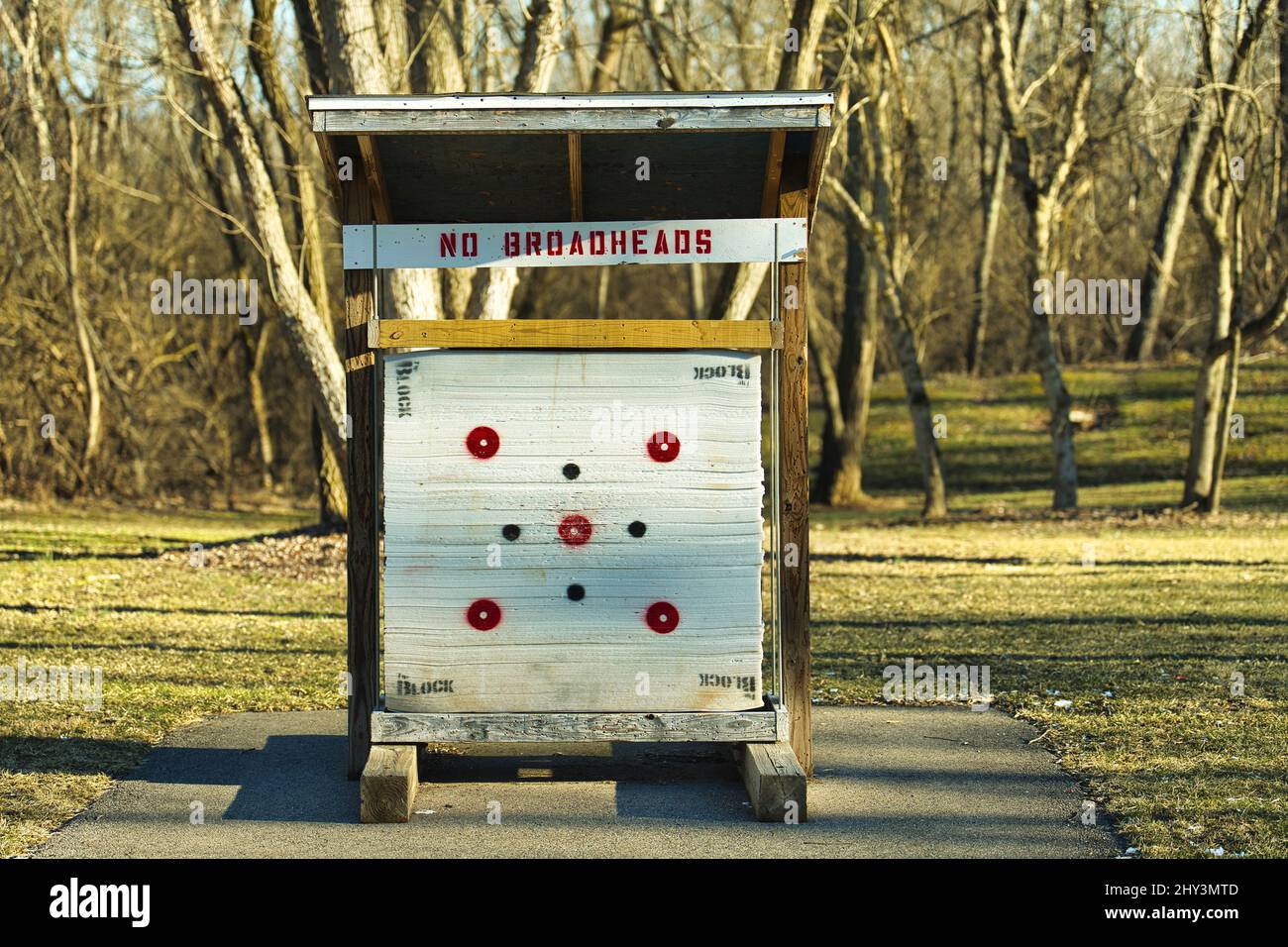 Beautiful shot of a wooden booth on the grass with trees in the park on ...