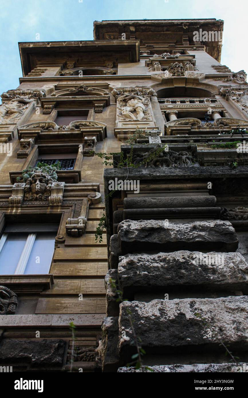 Low-angle shot of an ornamented stone building with carved sculptures ...