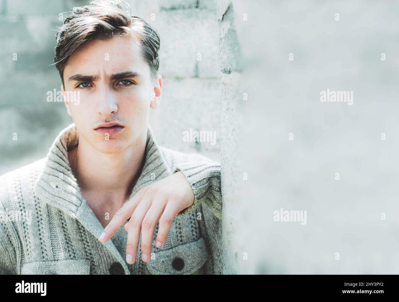 Portrait of self confident man. Close-up of young man against grey ...