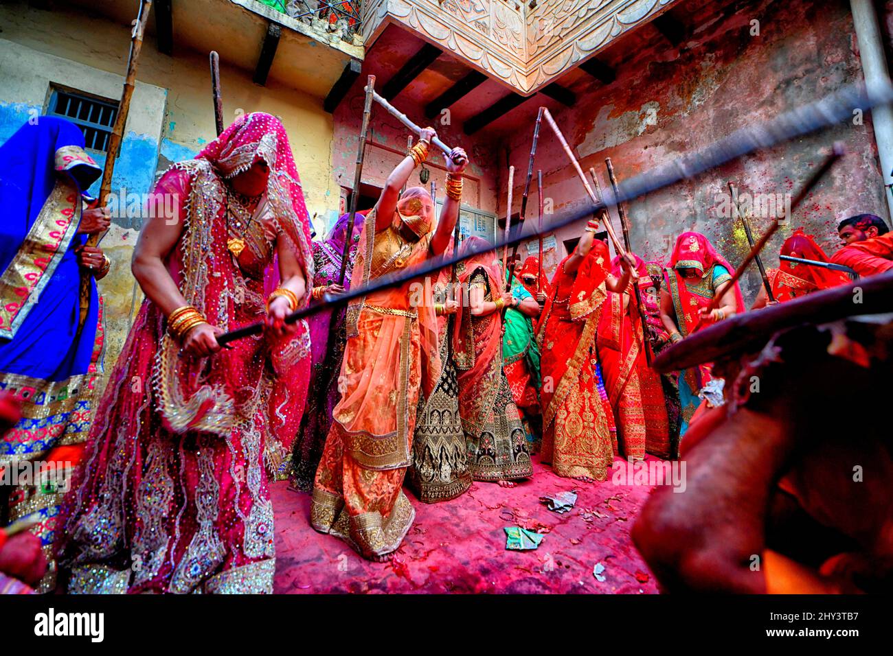 Vrindavan, India. 11th Mar, 2022. Women hold sticks (Lathi) ritually ...
