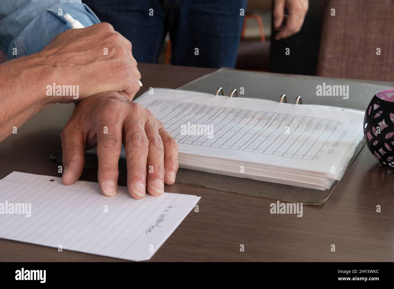 Closeup of the man's hands on the table with journal and paper Stock ...
