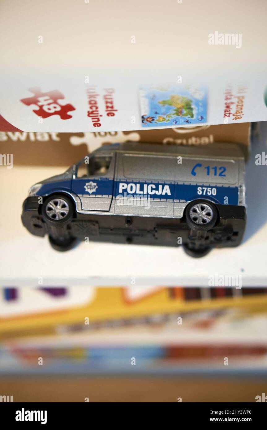 Toy model police van laying on a wooden shelf in a play room Stock ...
