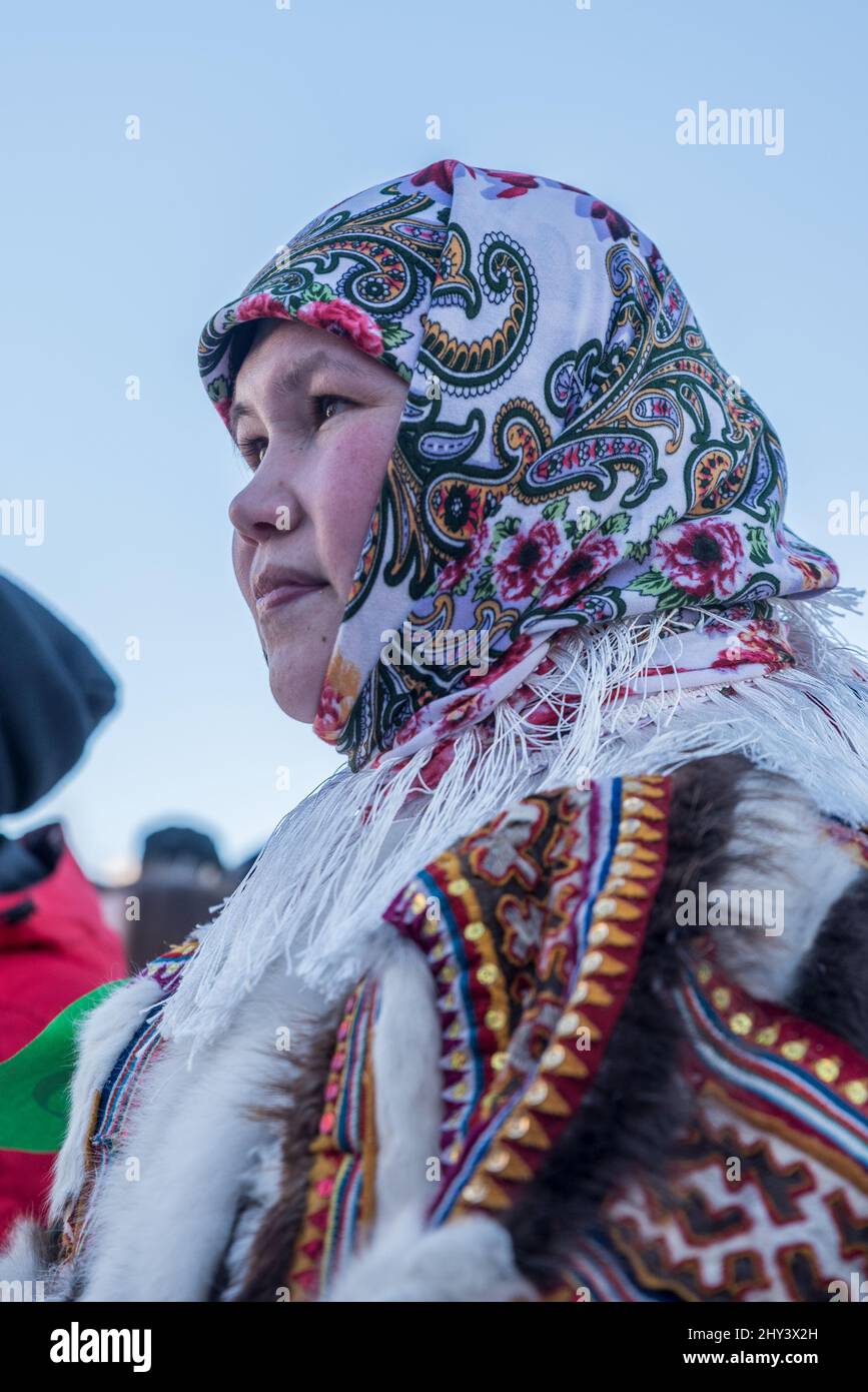 Young woman with colorful headscarf and traditional reindeer fur wear ...
