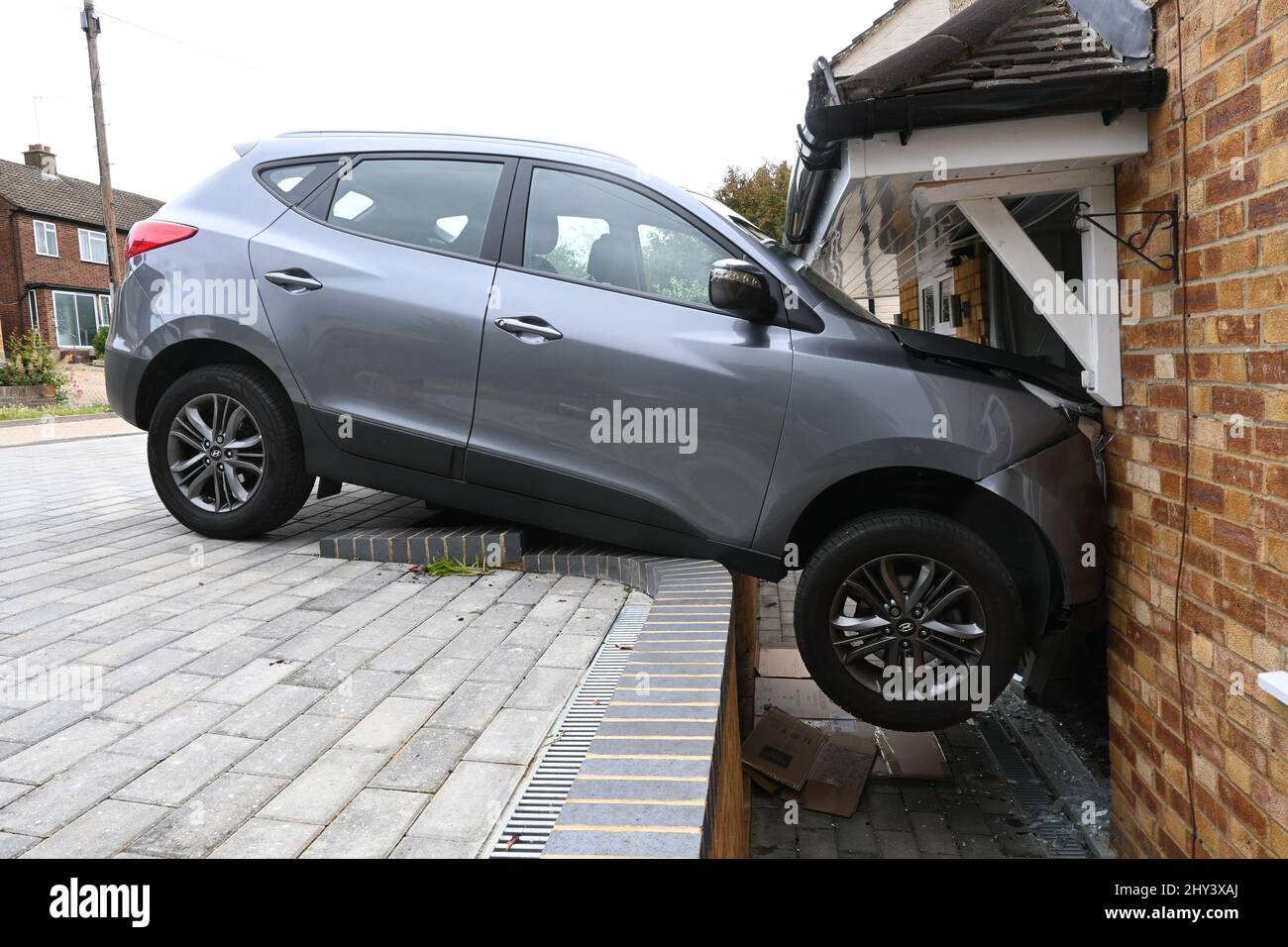 Close-up shot of a car crashed in a house off the driveway Stock Photo ...