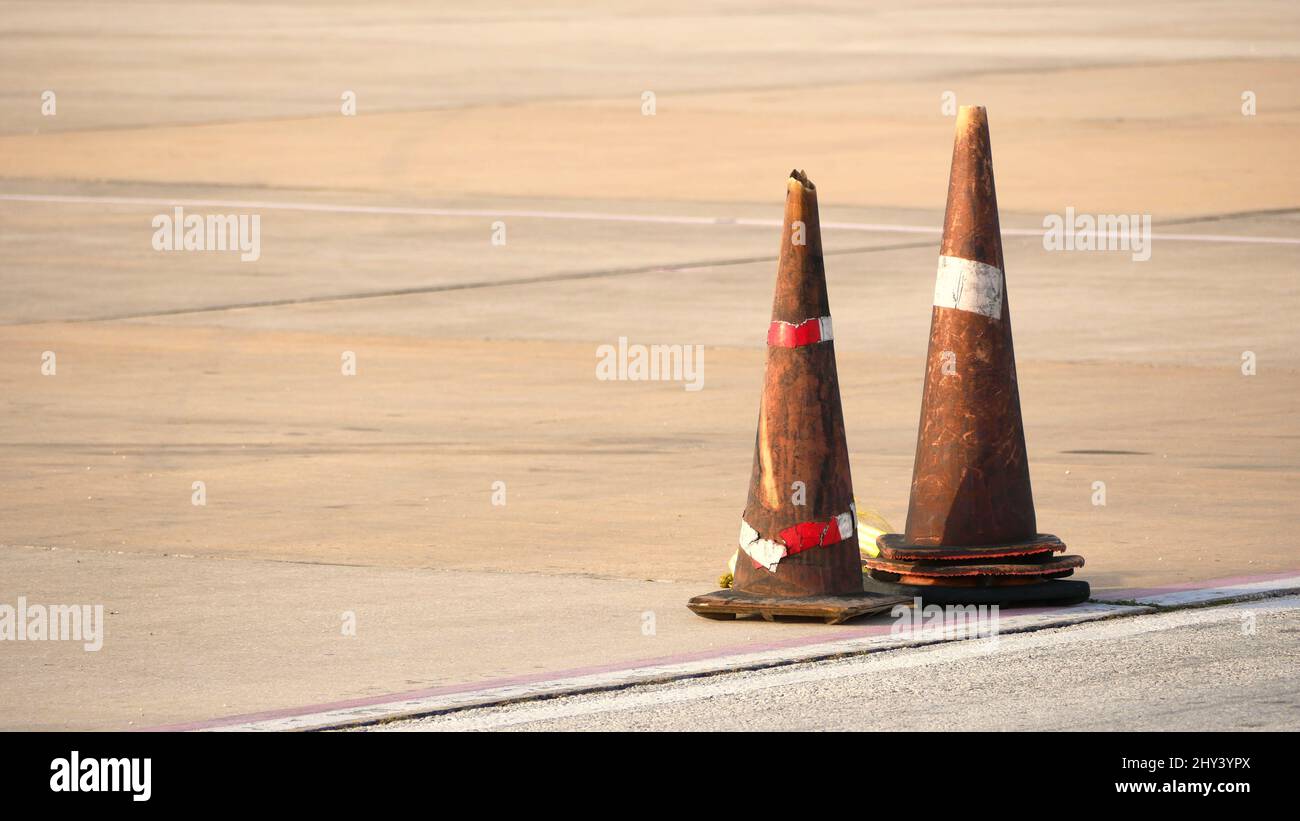 Shot of rusty two traffic cones on the road Stock Photo - Alamy
