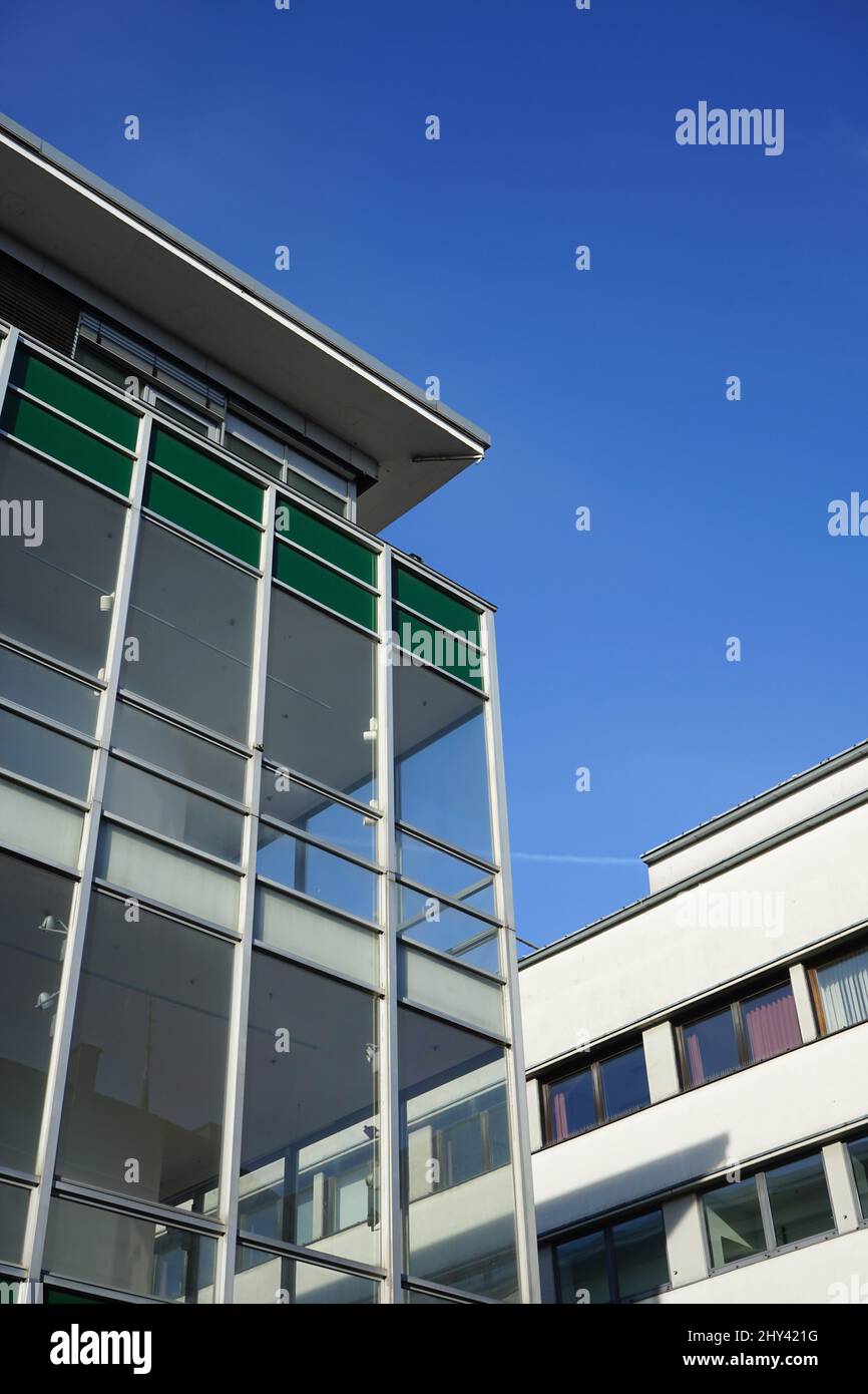 Vertical of a modern glass-walled building under a clear blue sky Stock ...