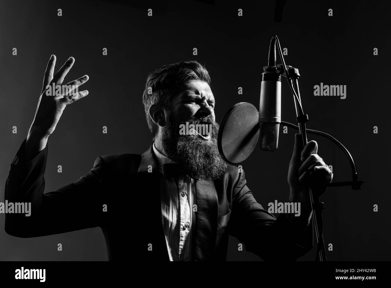 Singer gestures with hands. Man singing with music microphone Stock ...