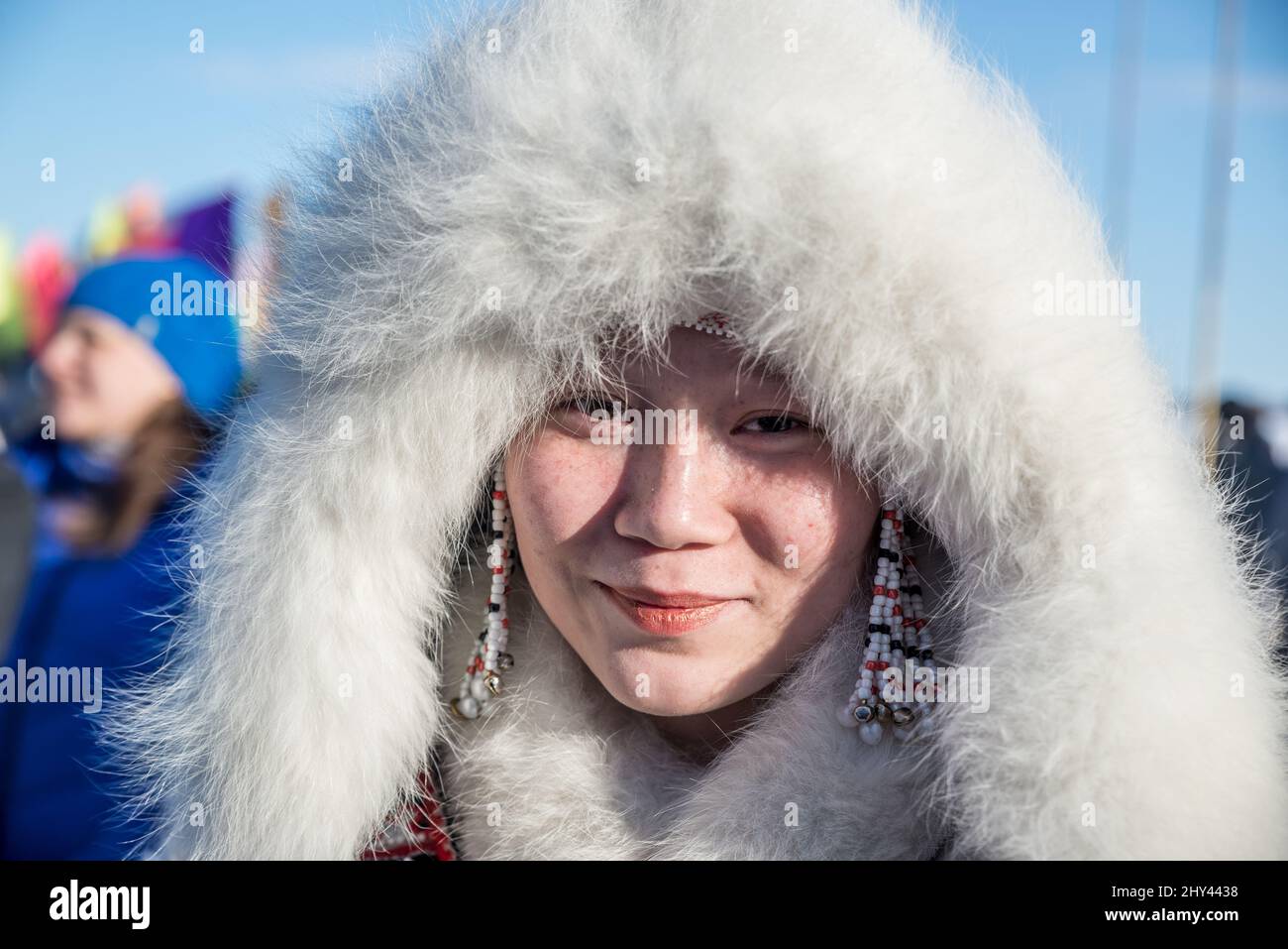 Portrait of a Nenet girl with traditional reindeer fur hood/headdress ...