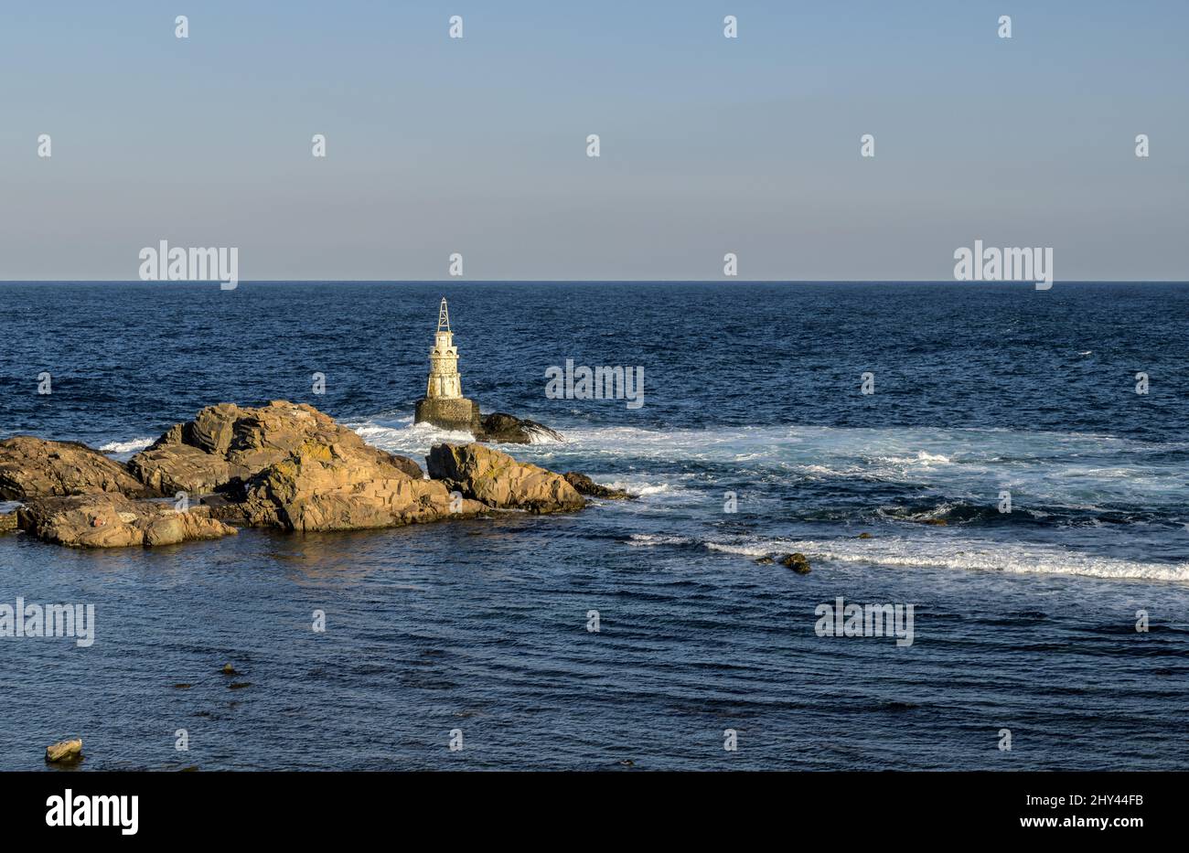 Old lighthouse of Ahtopol in Bulgaria under a blue sky on a sunny day ...