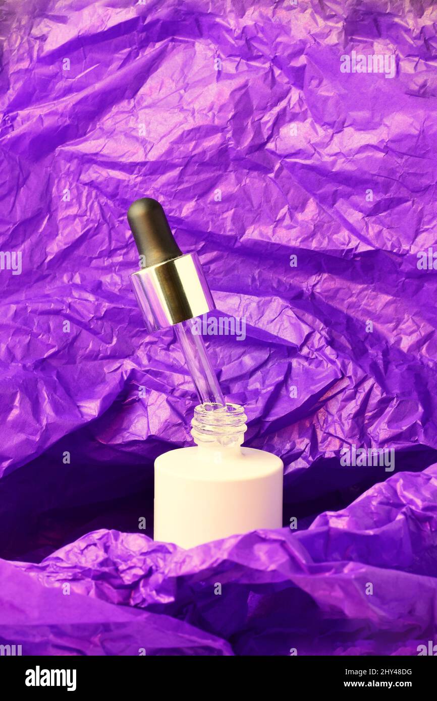 Vertical shot of a cosmetic container on a purple background Stock ...