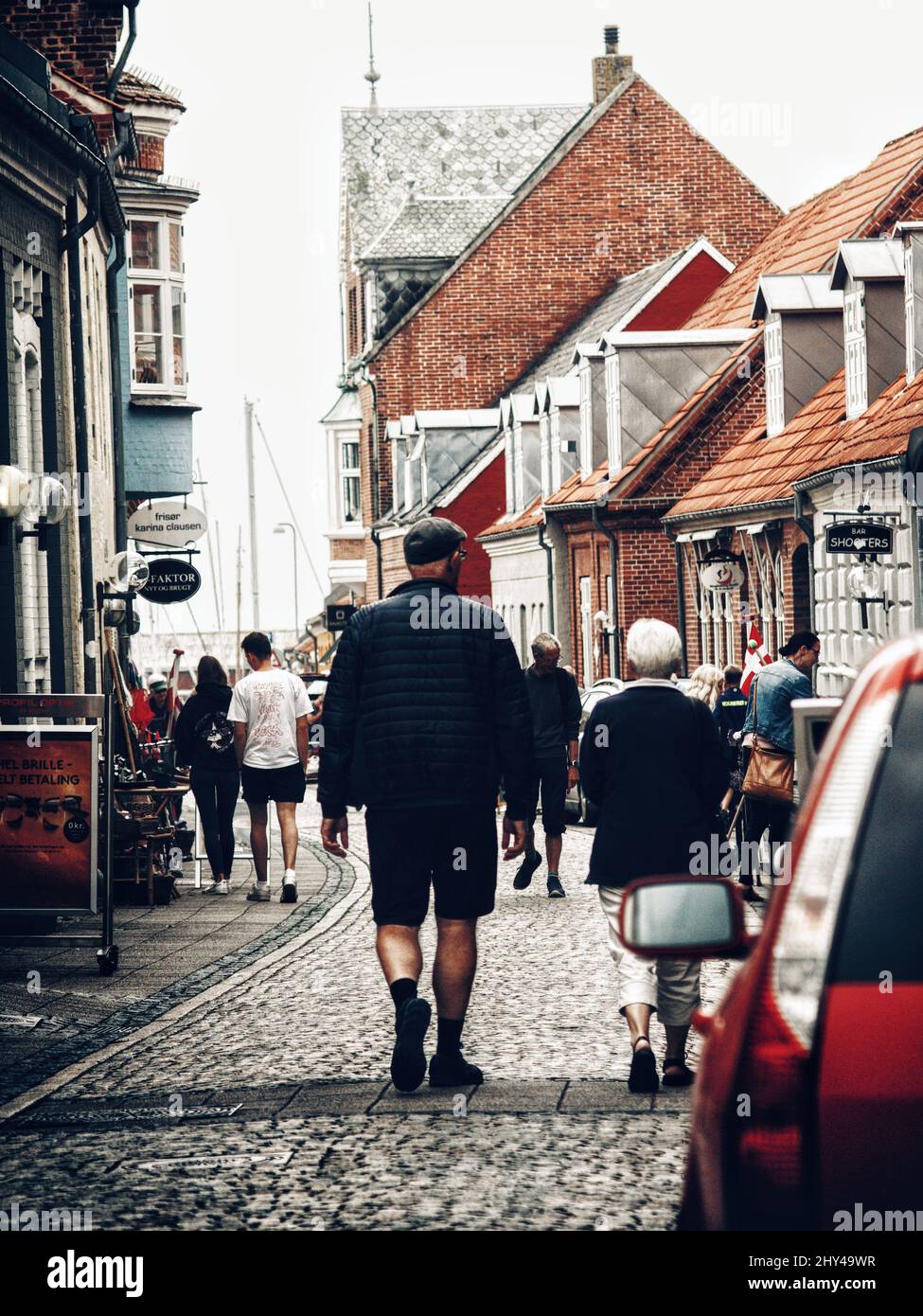 Closeup of people walking in shopping street of Ringkoebing, Denmark ...