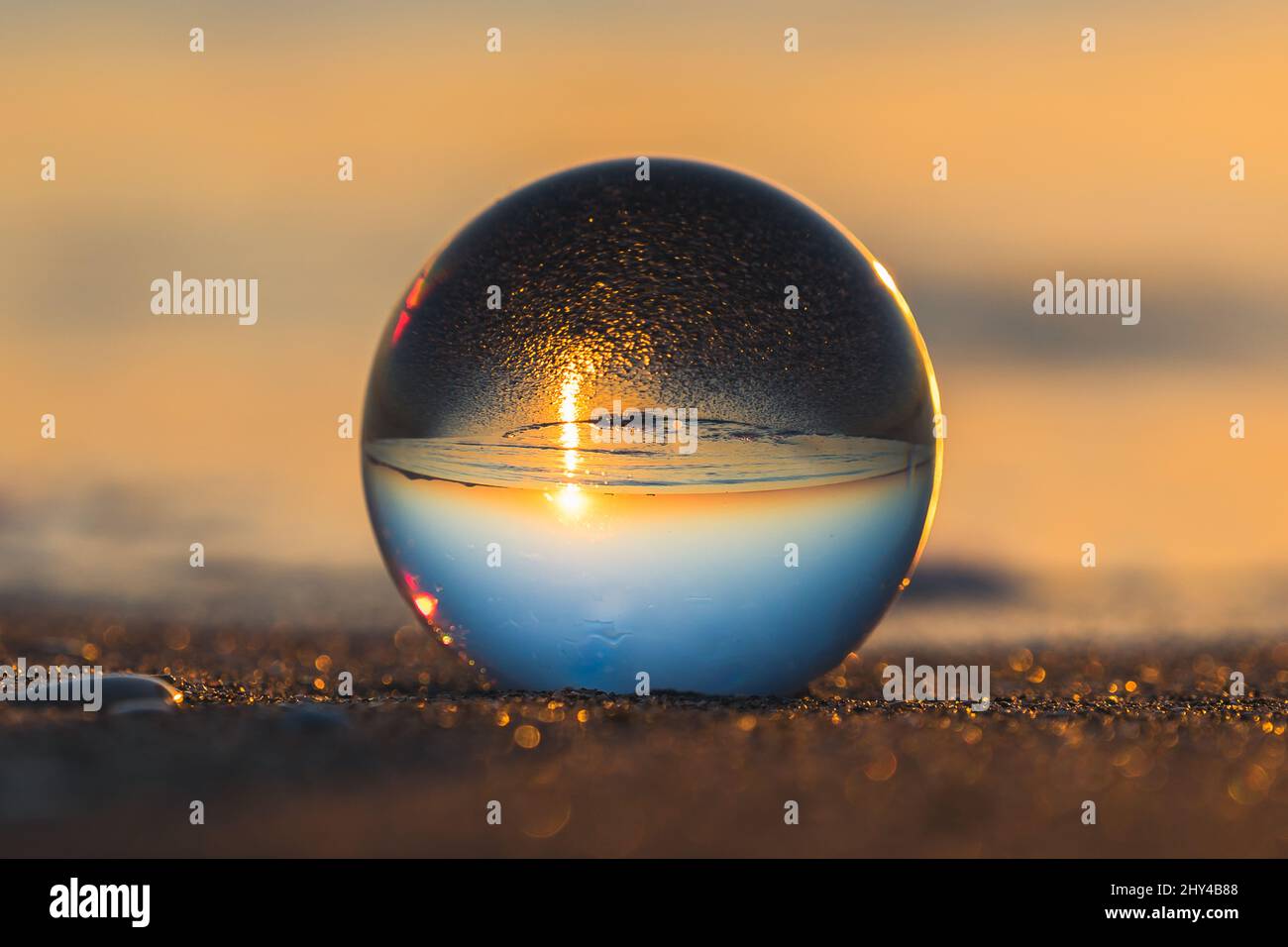 Closeup shot of a water bubble reflecting the seascape behind it Stock ...