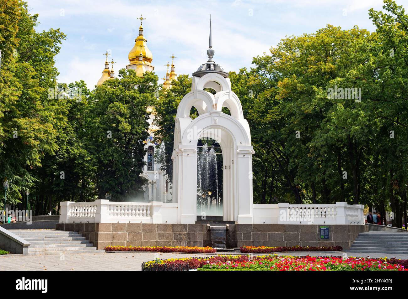 Mirror Stream fountain, park with flowers and green trees in summertime ...