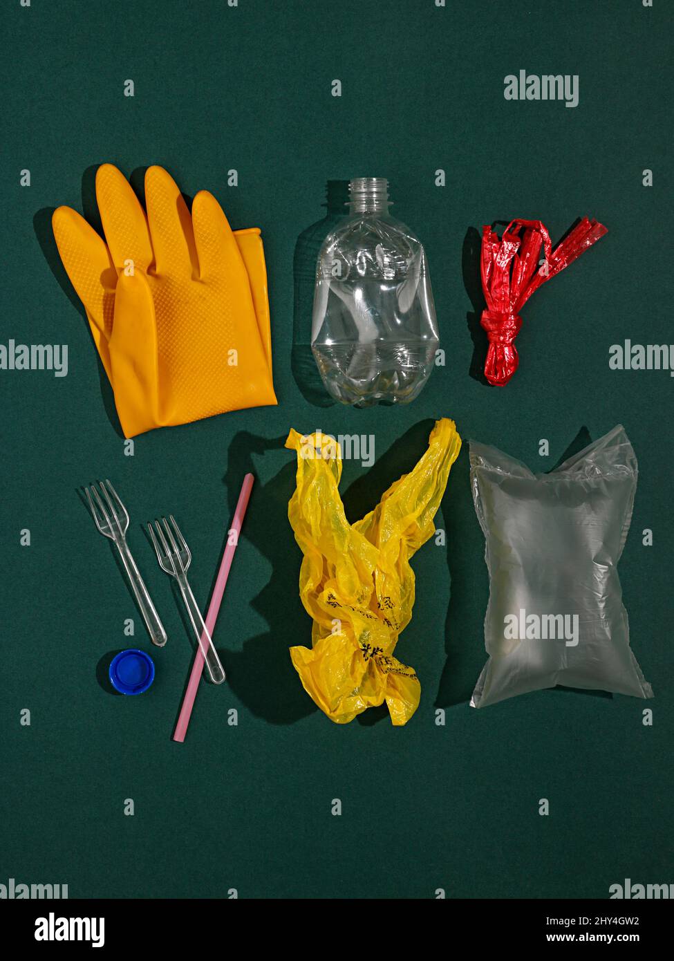 Vertical shot of the different garbage on the green background Stock ...