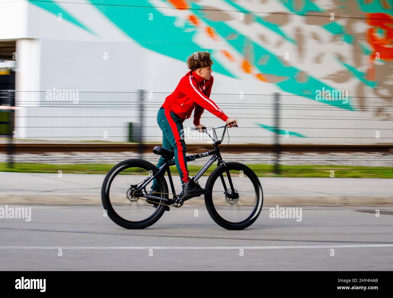 Boy riding a bicycle on the street Stock Photo - Alamy