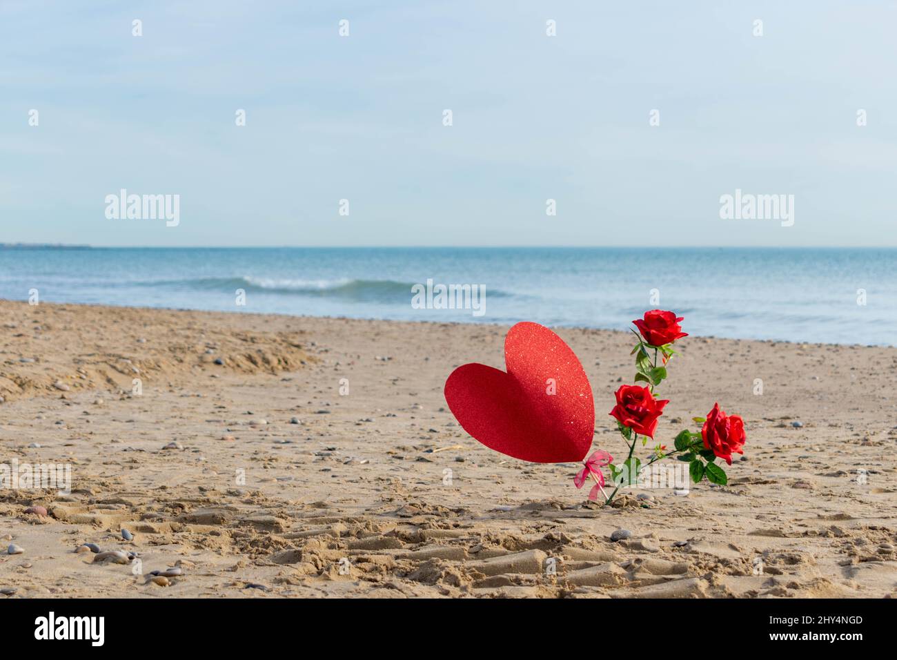 Beautiful view of red roses with red heart on the beach Stock Photo - Alamy