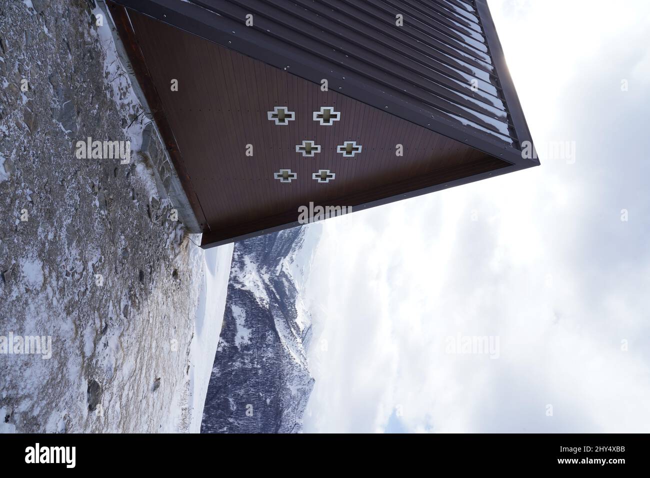 Winter triangle cabin with a view of a snowy mountainous landscape ...