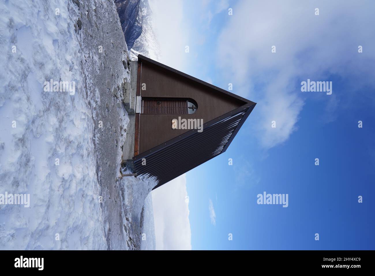 Winter triangle cabin with a view of a snowy mountainous landscape ...