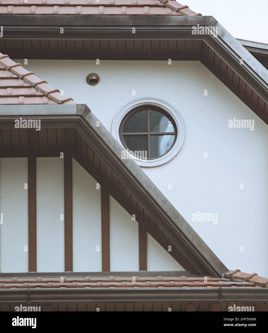 Shot of a small circle window on the wall of modern house Stock Photo ...