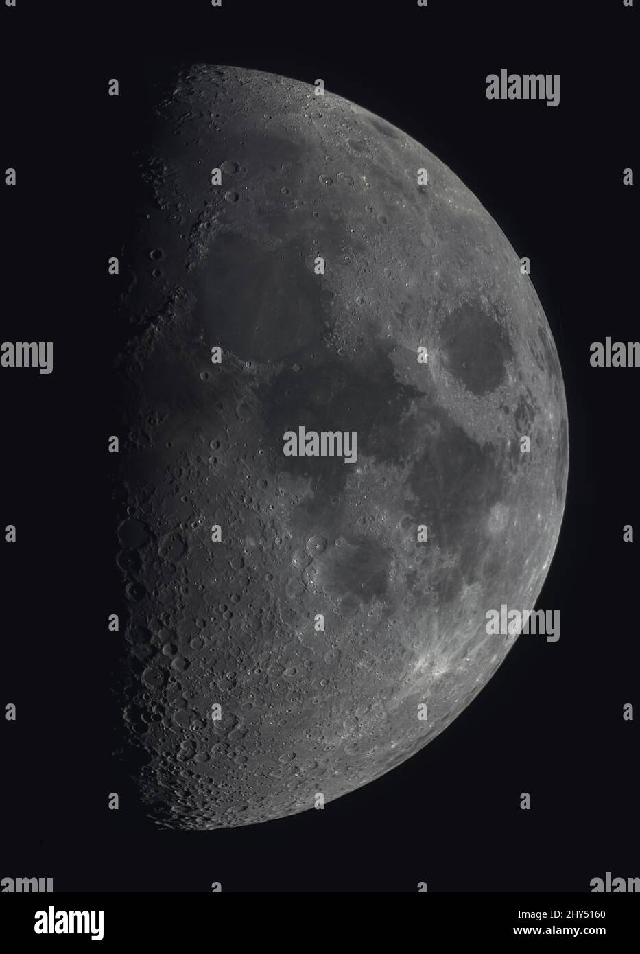 Vertical grayscale shot of the moon in the night sky Stock Photo - Alamy