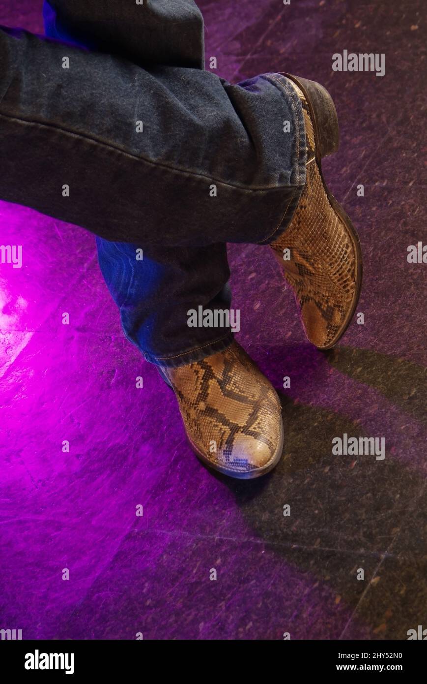 Closeup of a man's cowboy boots in a nightclub in Missouri Stock Photo ...