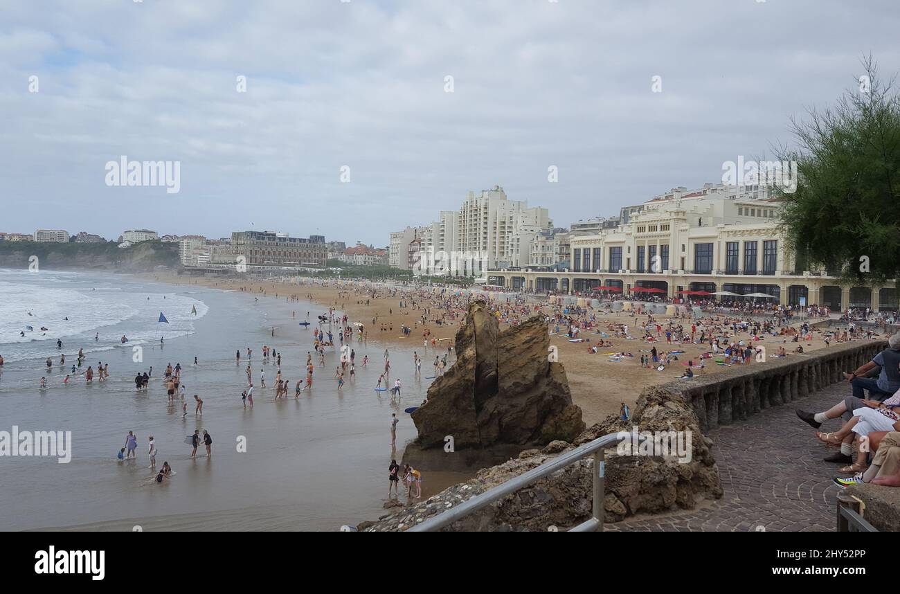 Bunch of people enjoing themselves on the beach in Biarritz, France ...