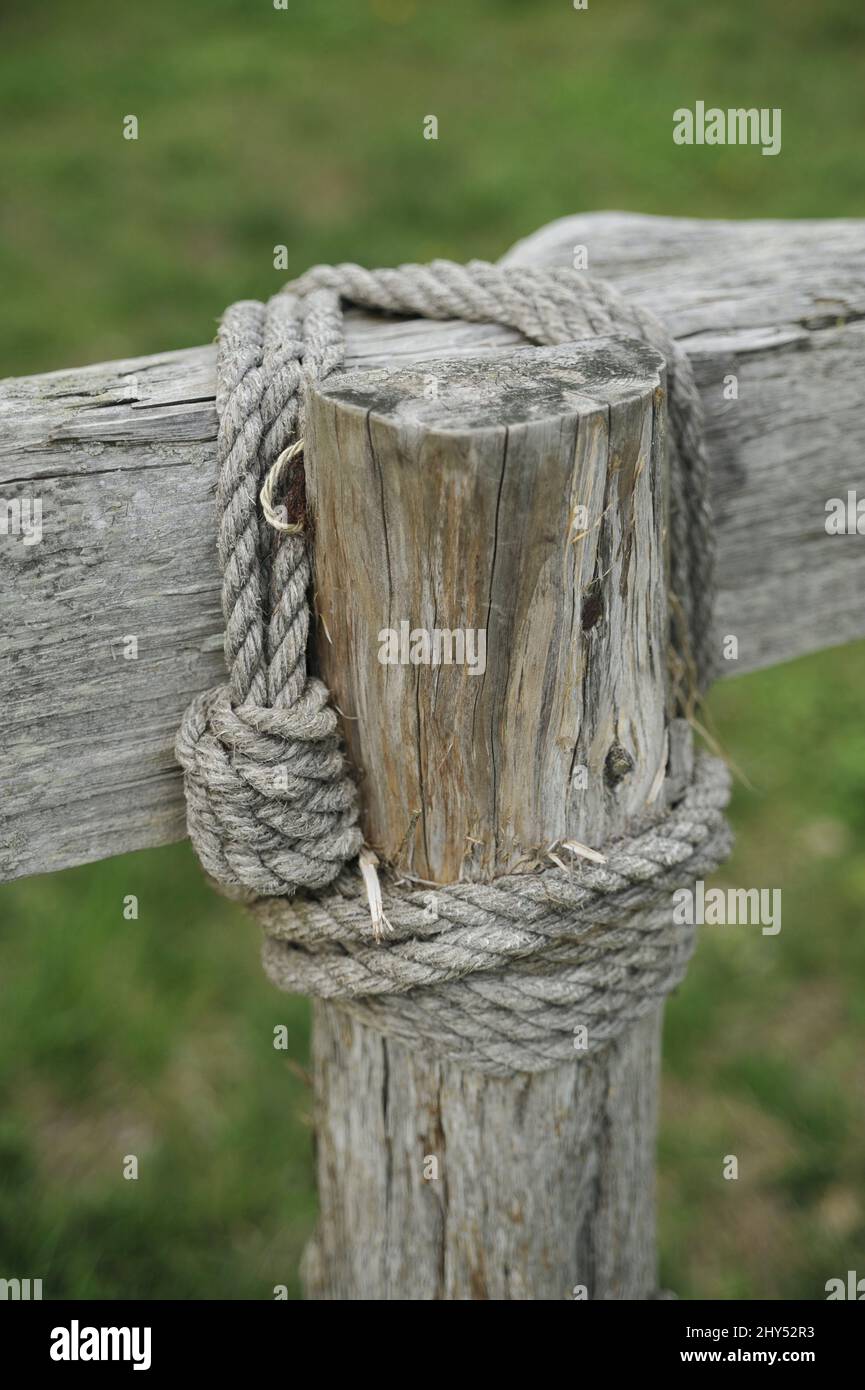 Wooden fence post and rail secured by rope on a farm in Missouri Stock ...