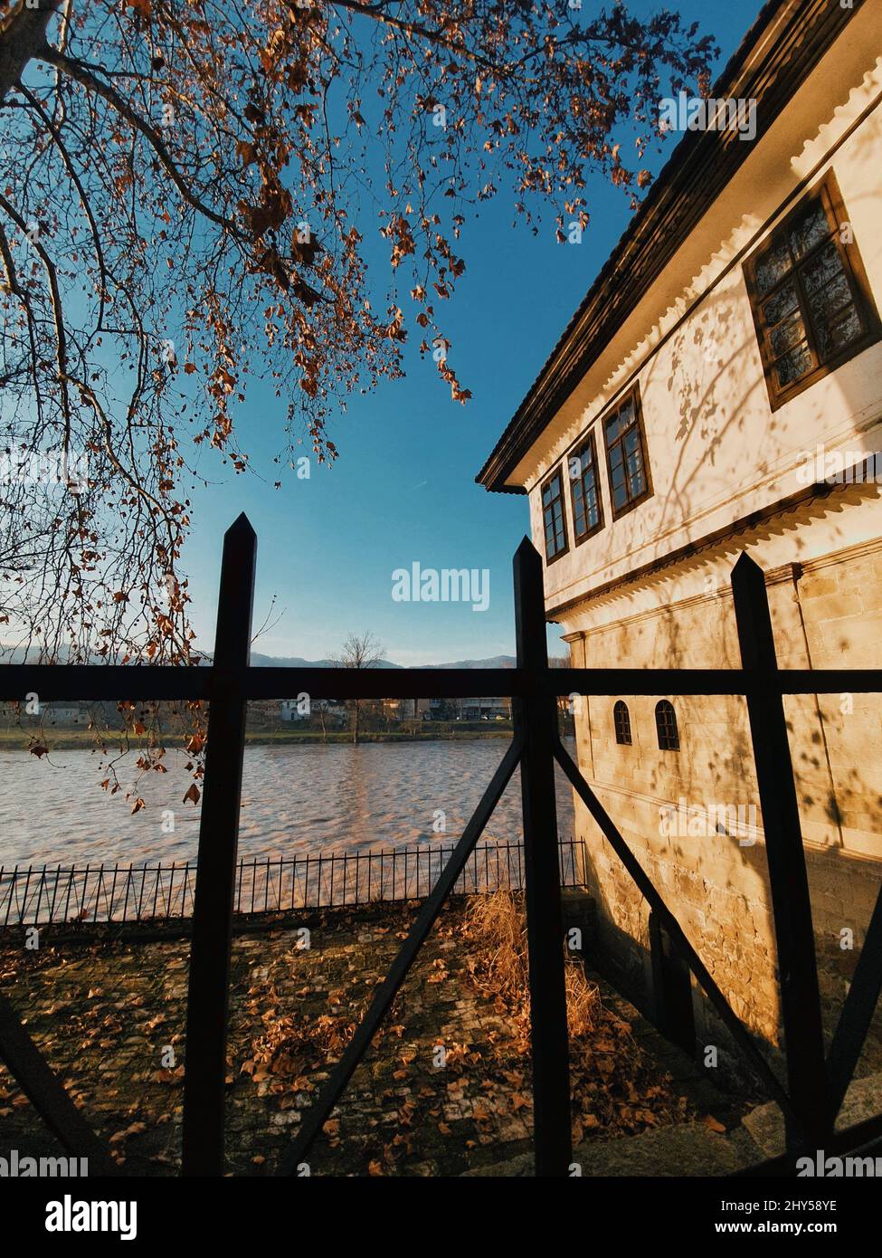 Beautiful view of an old building with a garden by the lake Stock Photo ...