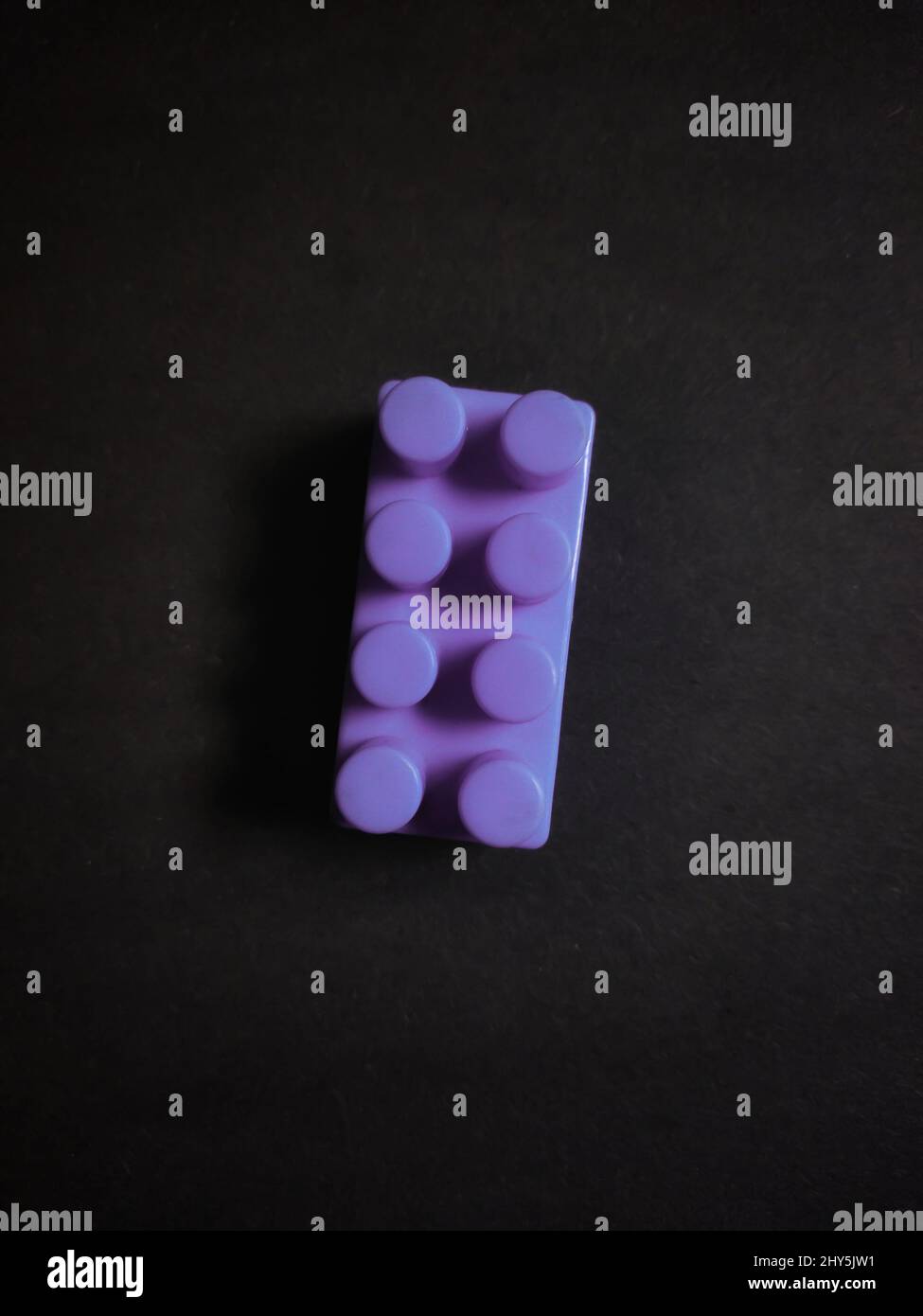 Top view of a purple lego block on a black surface Stock Photo - Alamy