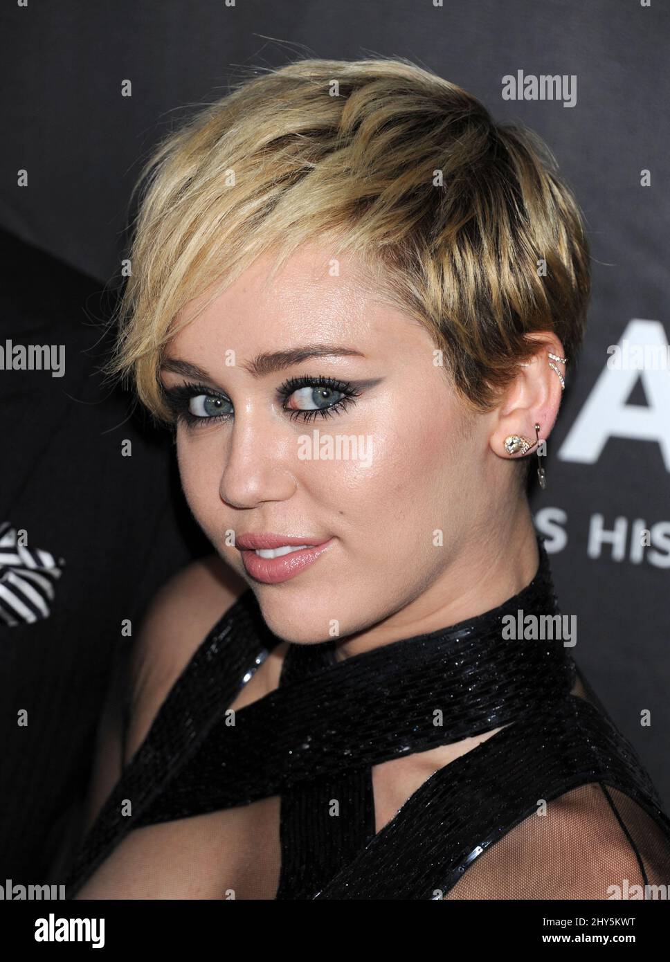 Miley Cyrus arrives at the 2014 amfAR Inspiration Gala at Milk Studios ...