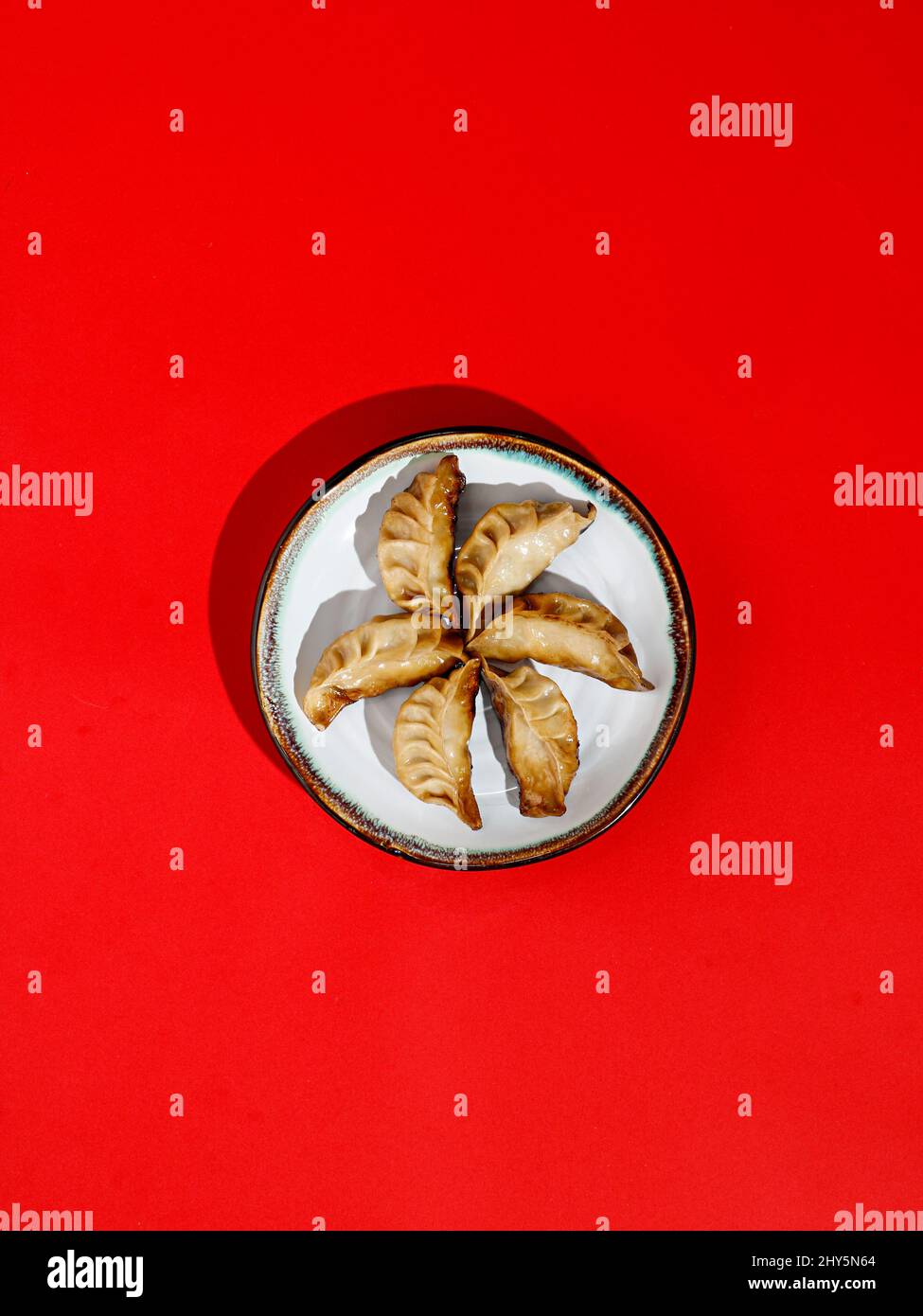 Top view of Chinese dumplings (Jiaozi) arranged in a circle in a white ...