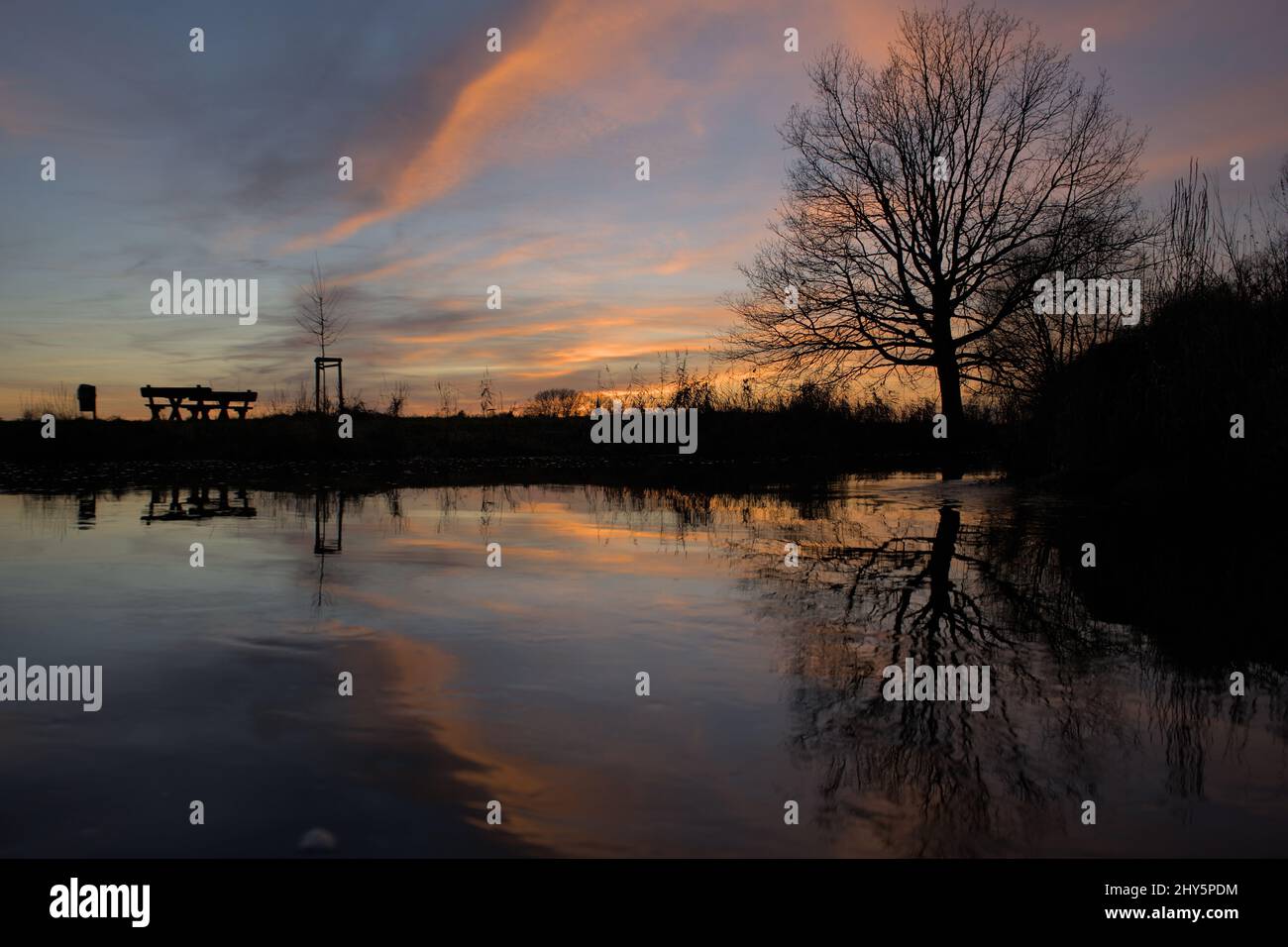 View of a river with magical sunset reflection Stock Photo - Alamy