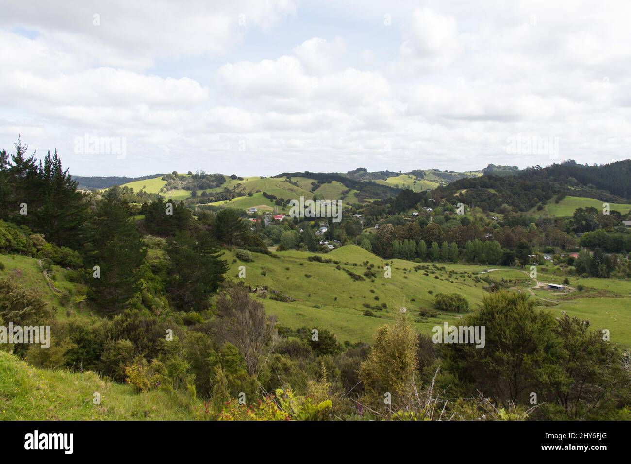 The view of countryside landscape with green hills, forest and village ...