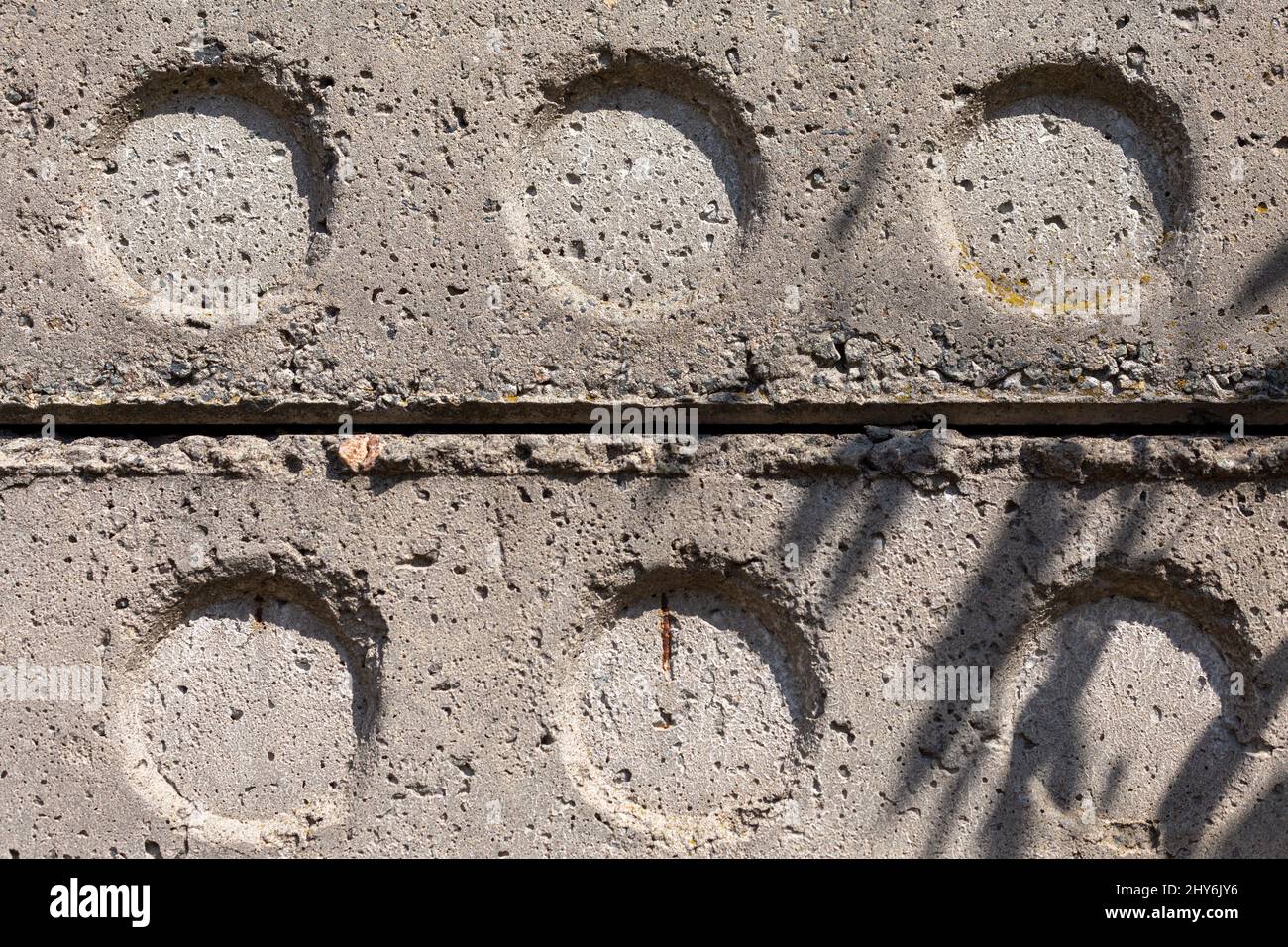 Linear texture of old gray concrete slabs block with holes stacked on ...