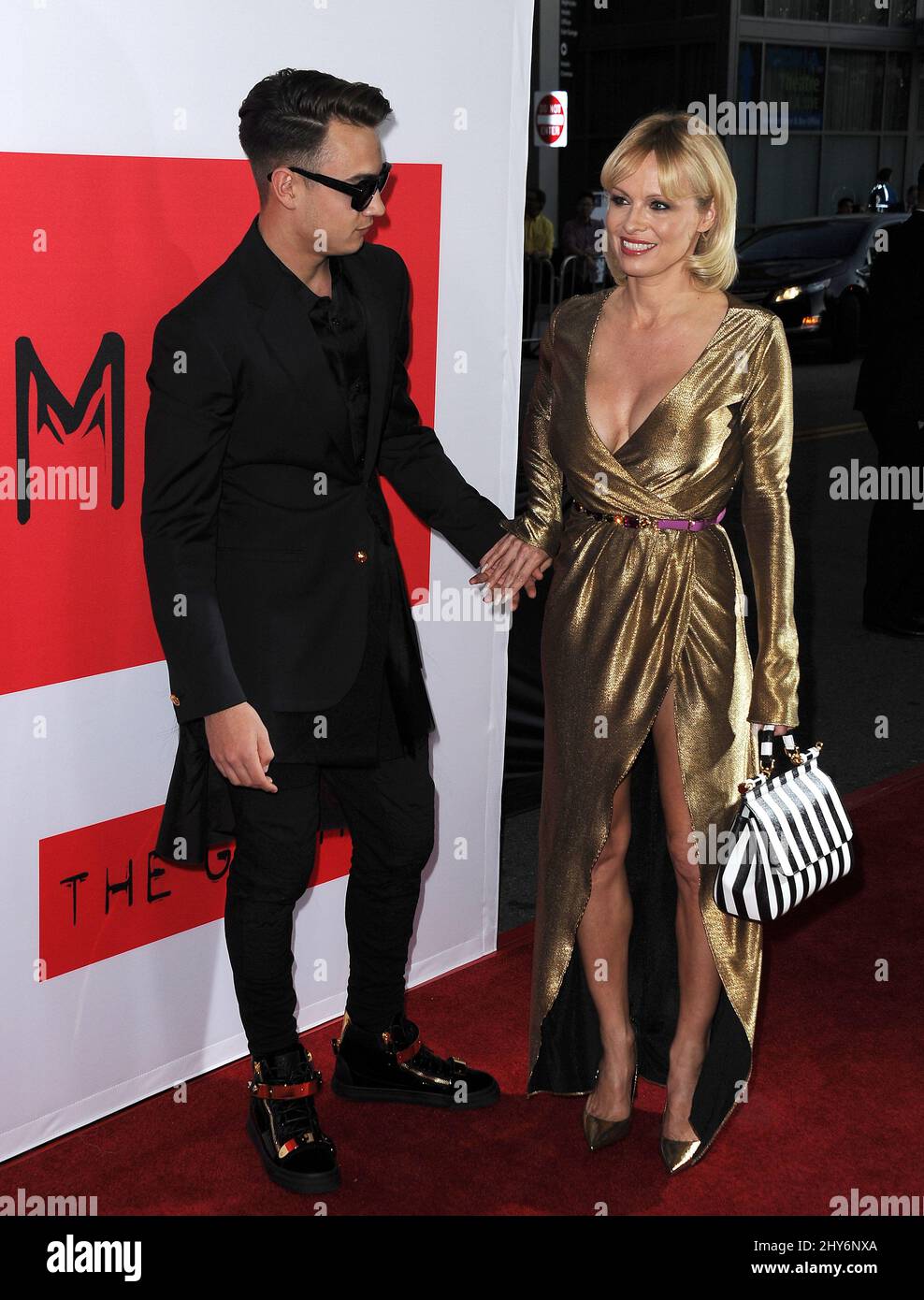 Pamela Anderson, Brandon Thomas Lee attending "The Gunman" Los Angeles ...