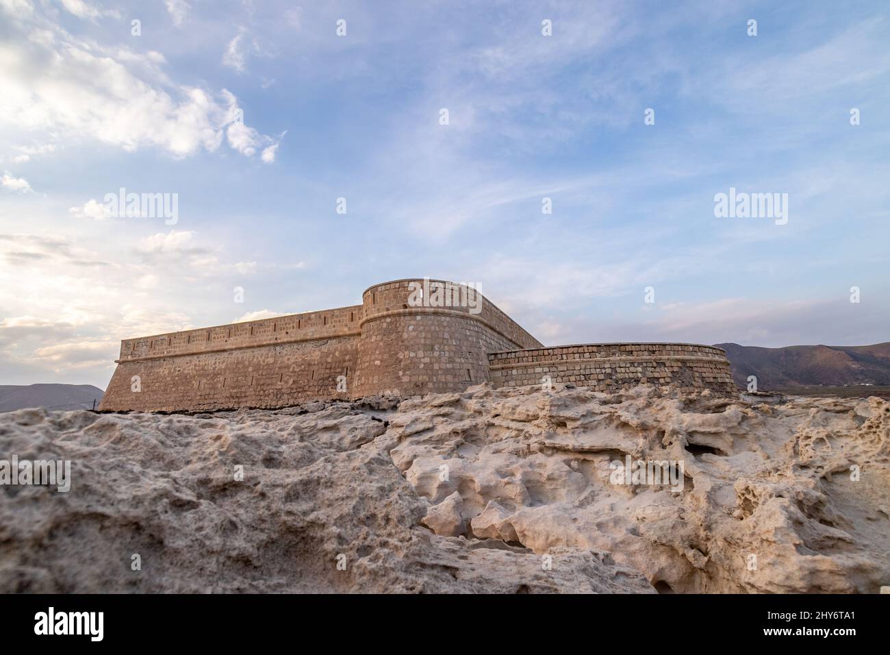 Historic abandoned military fortress on a beach under a blue sky in ...