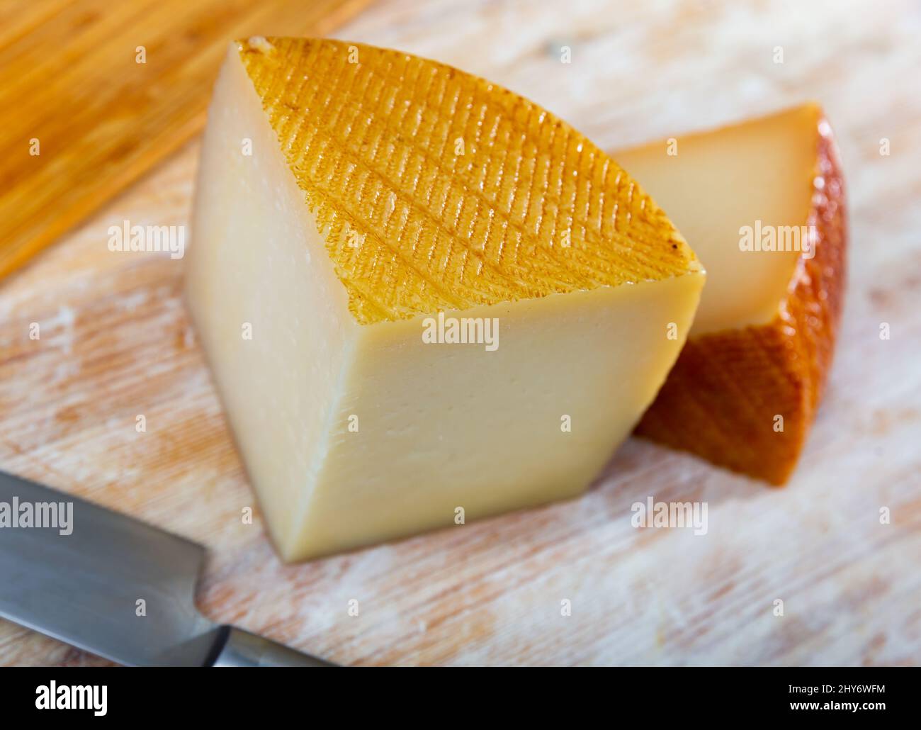 Traditional Spanish cheese — with ivory color and small irregular holes ...