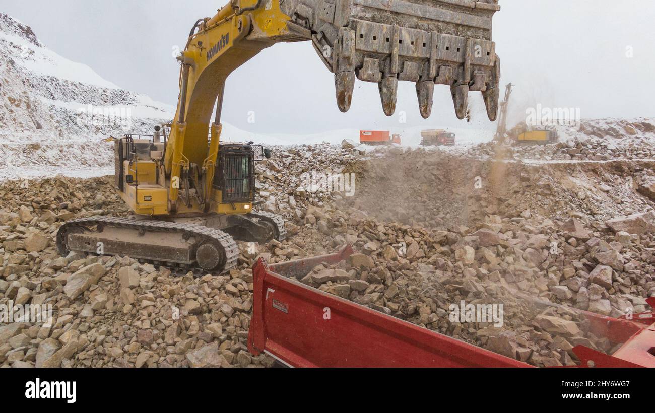 tracked excavator loading the material in a truck Stock Photo - Alamy