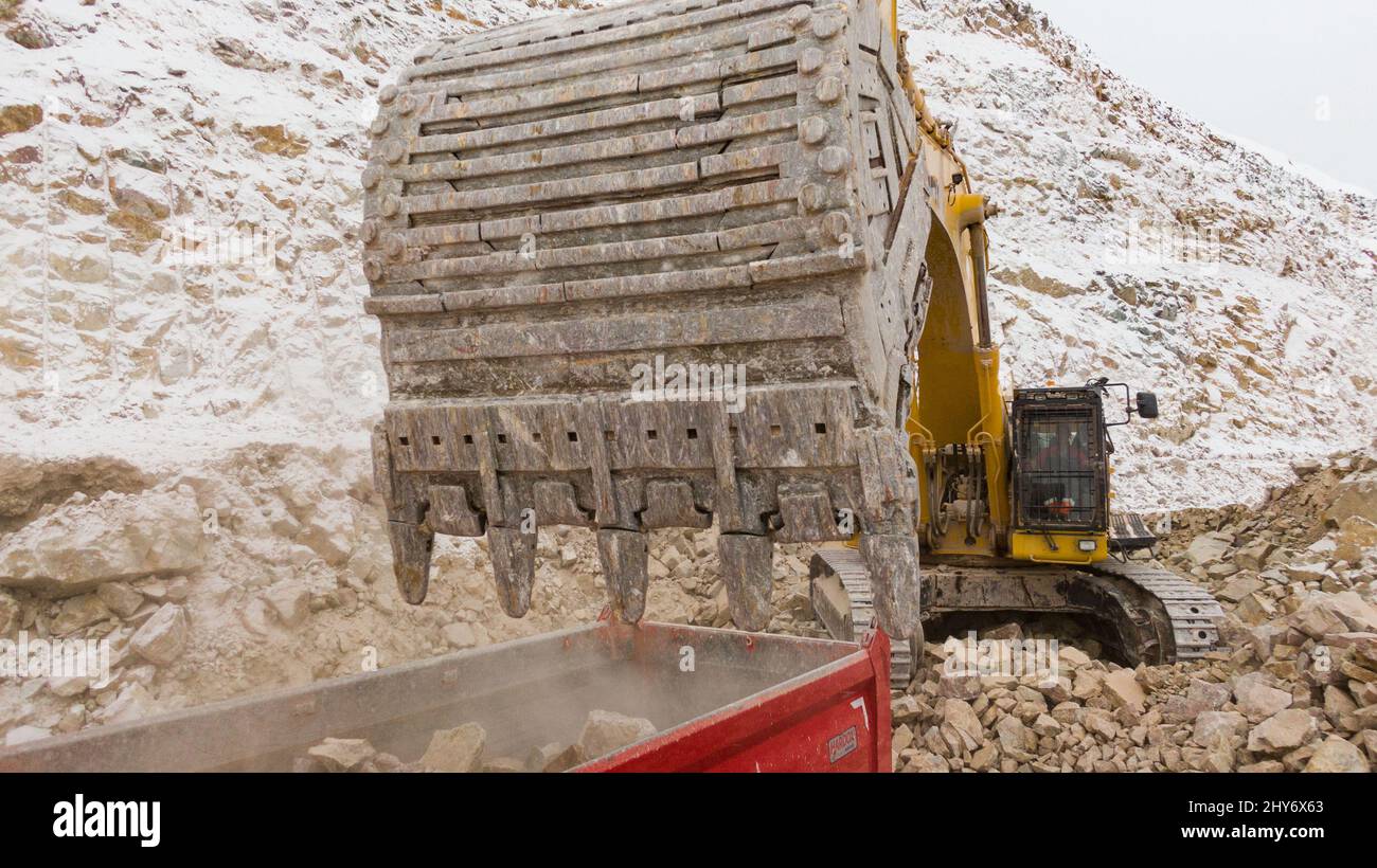 tracked excavator loading the material in a truck Stock Photo - Alamy
