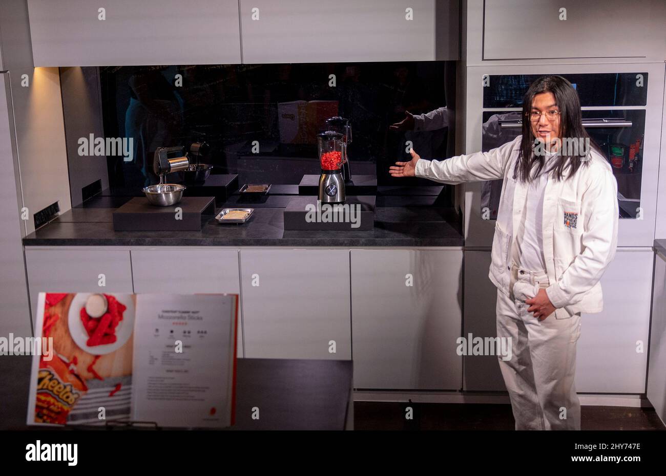 Austin, USA. 14th Mar, 2022. An exhibitor introduces the Cheetos hands ...