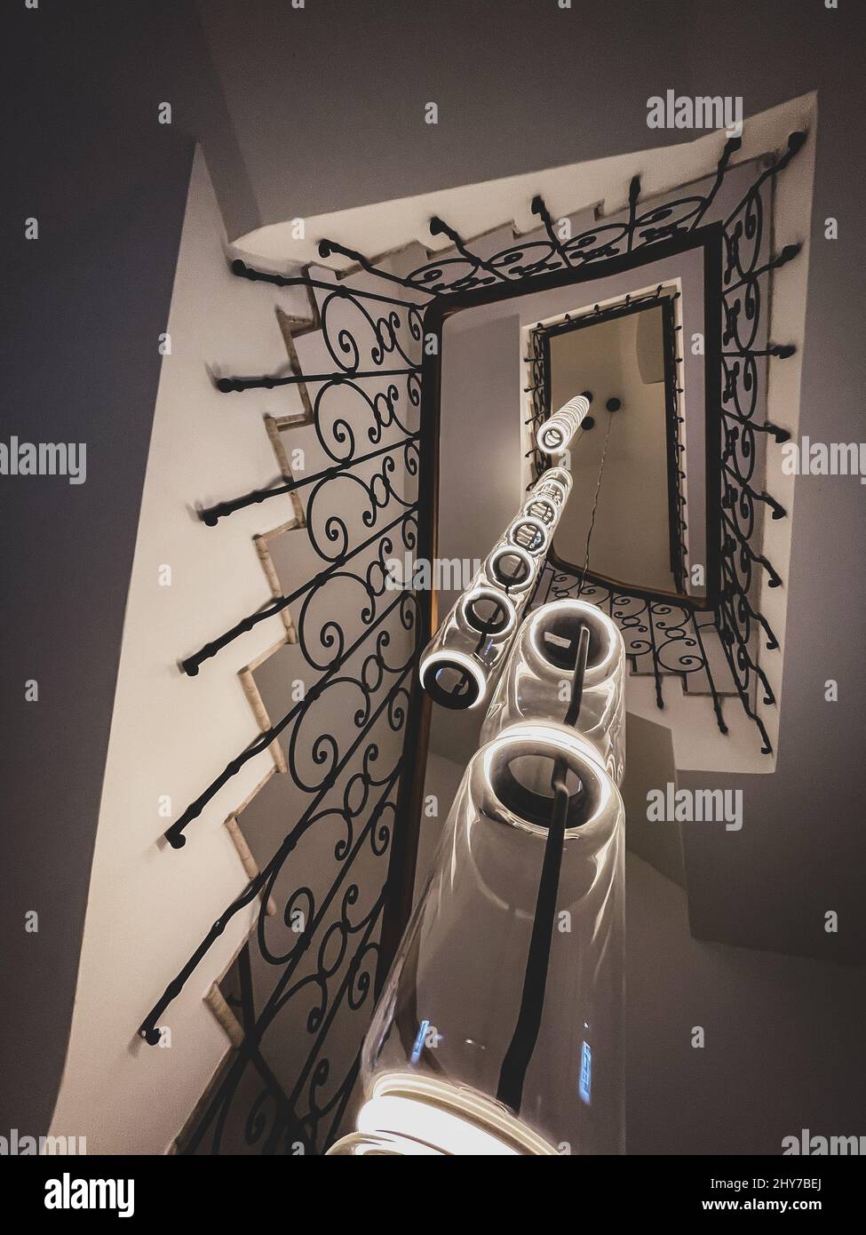 Low angle shot of a modern interior with the stairs and hanging glass ...