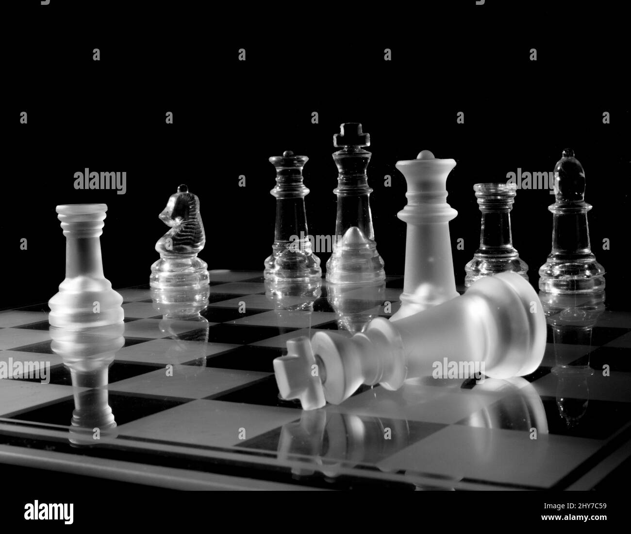 Fallen white king on a chessboard - concept of victory Stock Photo - Alamy