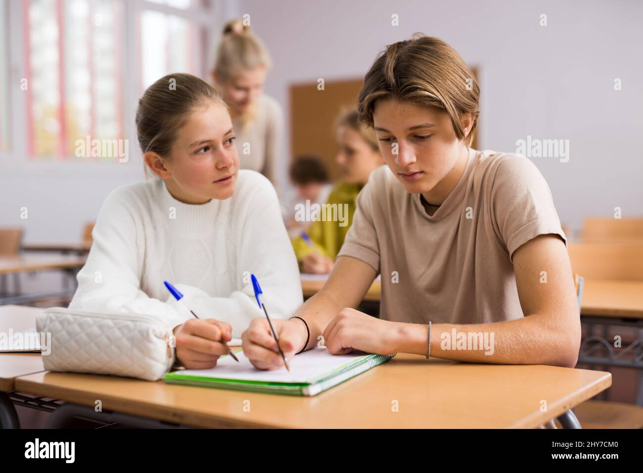 Group of school kids and teacher during lesson Stock Photo - Alamy