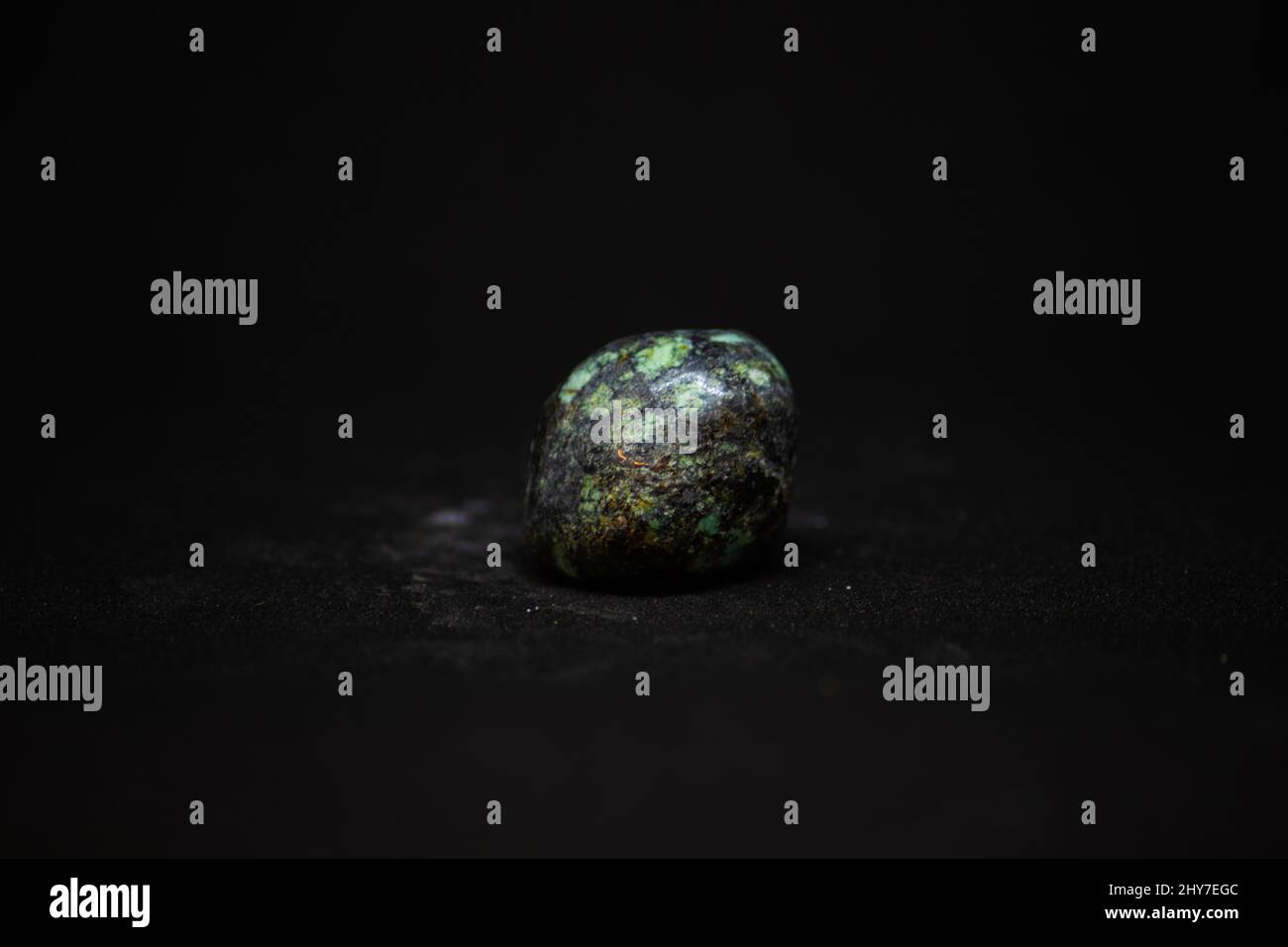 Photo of a small expensive mineral on a black background Stock Photo ...