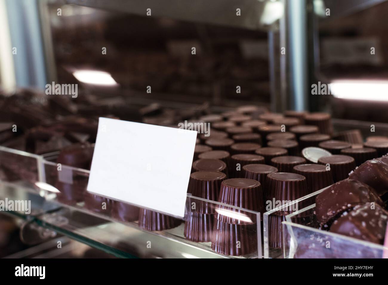 Closeup chocolate on display shelf on showcase in store with Mockup ...