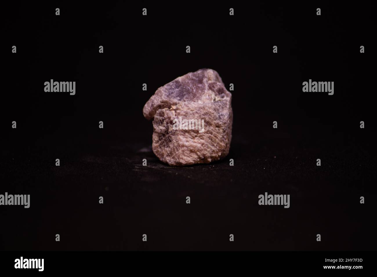 Shot of a small expensive mineral on a black background Stock Photo - Alamy