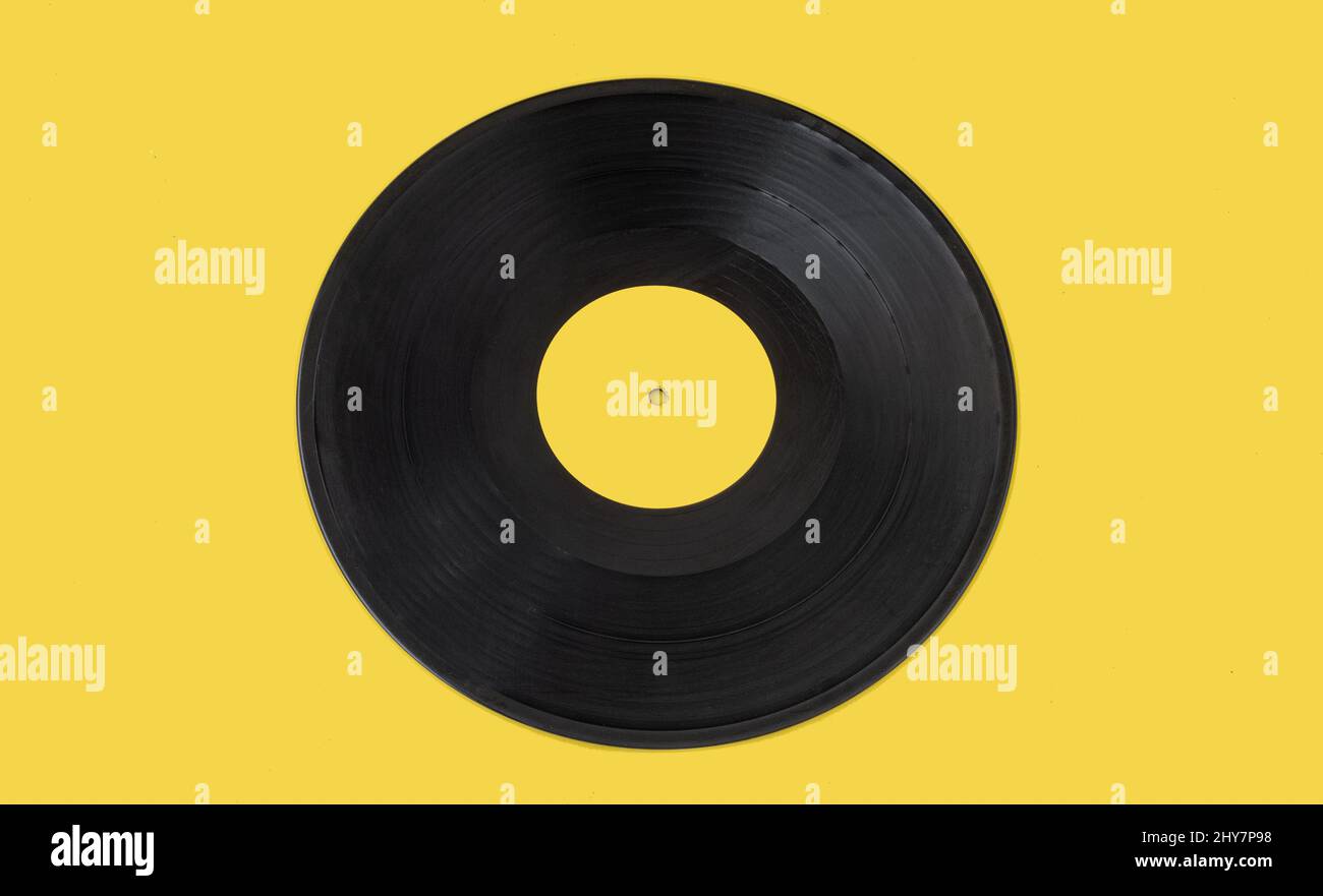 Closeup of a gramophone disc record on a yellow background Stock Photo ...