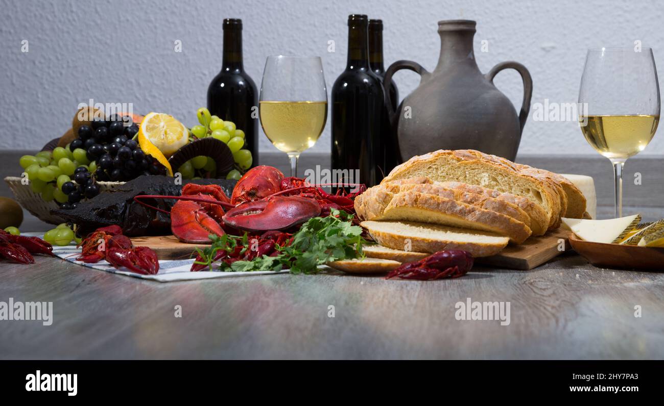 Still life with tasty seafood, wine, cheese and bread Stock Photo - Alamy