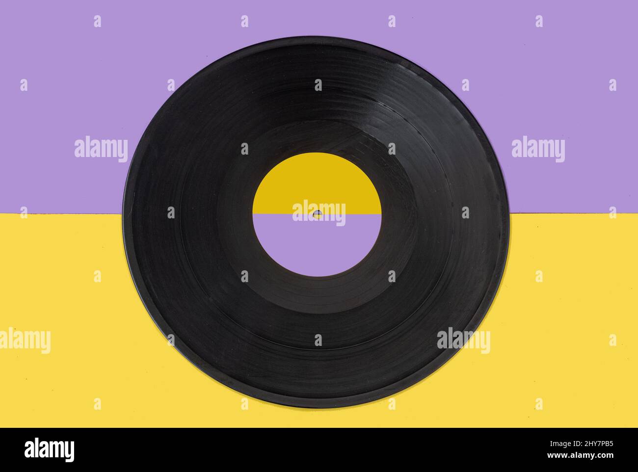 Closeup of a gramophone disc record on a yellow background Stock Photo ...